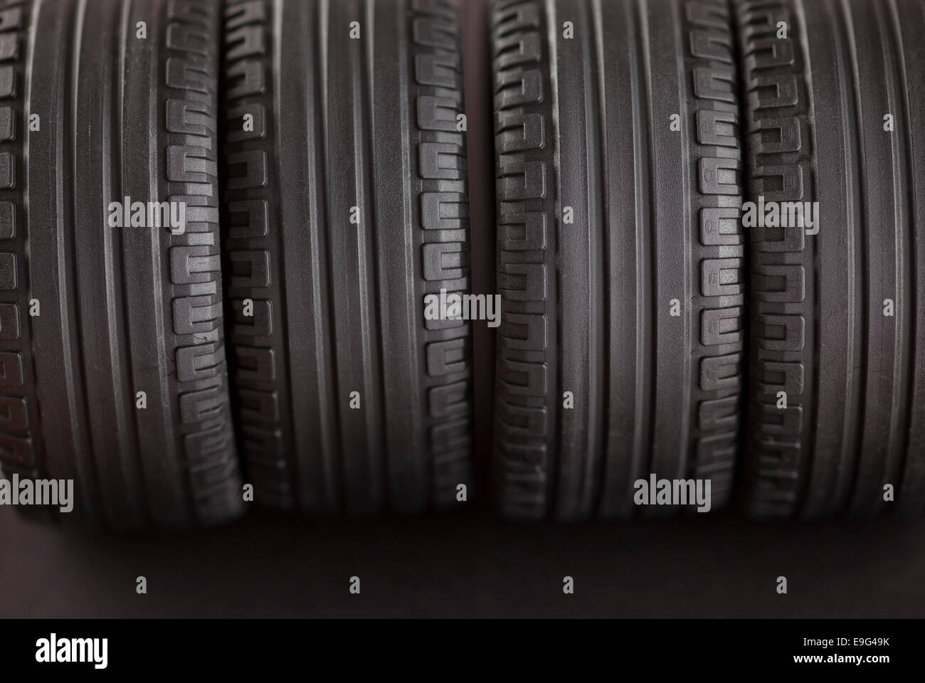 Four tires on black background Stock Photo - Alamy