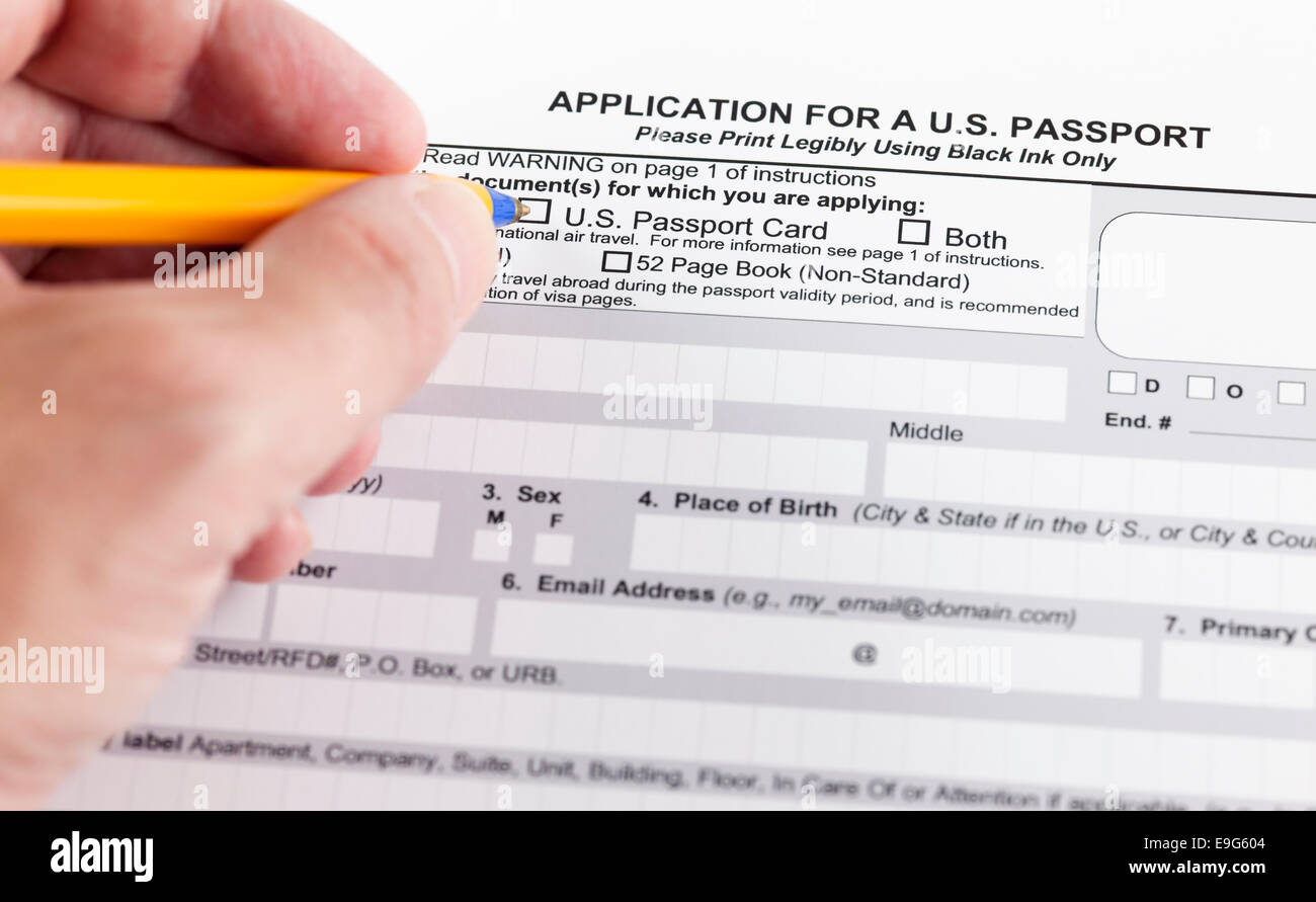 Application for a U.S. passport and human hand with ballpoint pen Stock ...