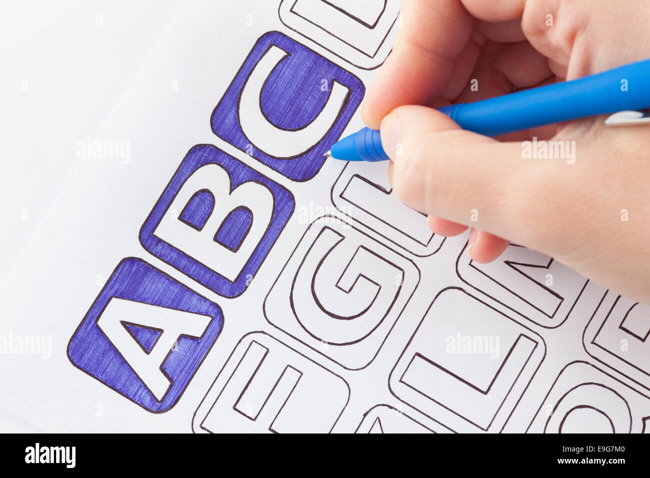 Woman's hand with ballpoint pen draw alphabet. A, B, C letters with ...