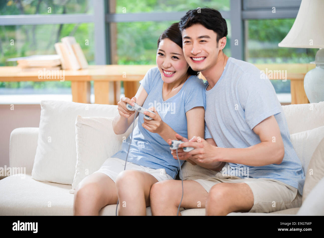Young couple playing video games together Stock Photo - Alamy