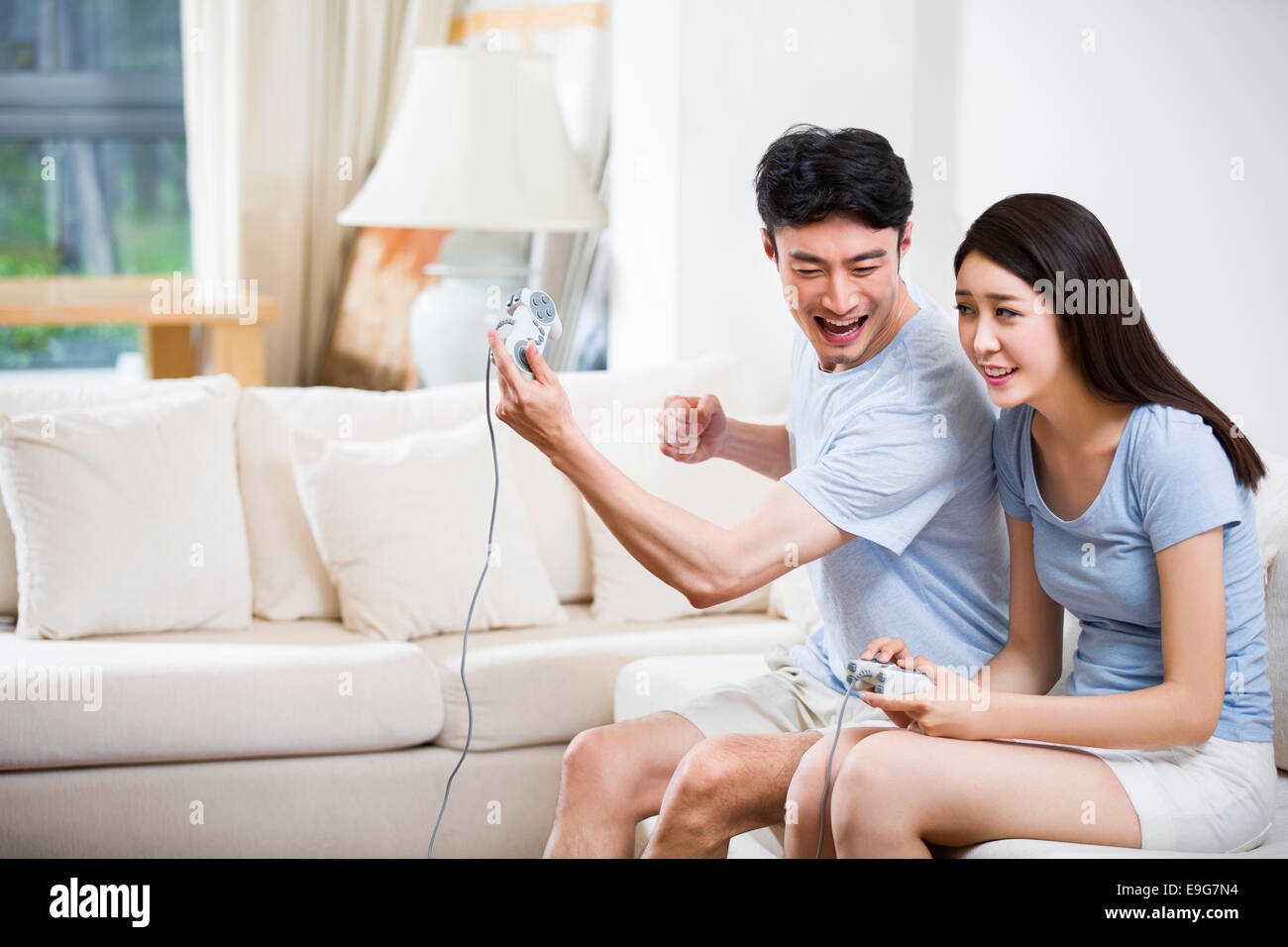 Young couple playing video games together Stock Photo - Alamy