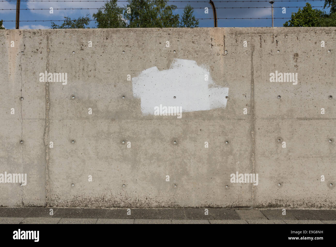 Large concrete wall with fence and sideway Stock Photo - Alamy