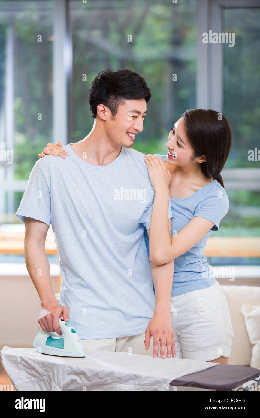 Young couple doing housework Stock Photo - Alamy