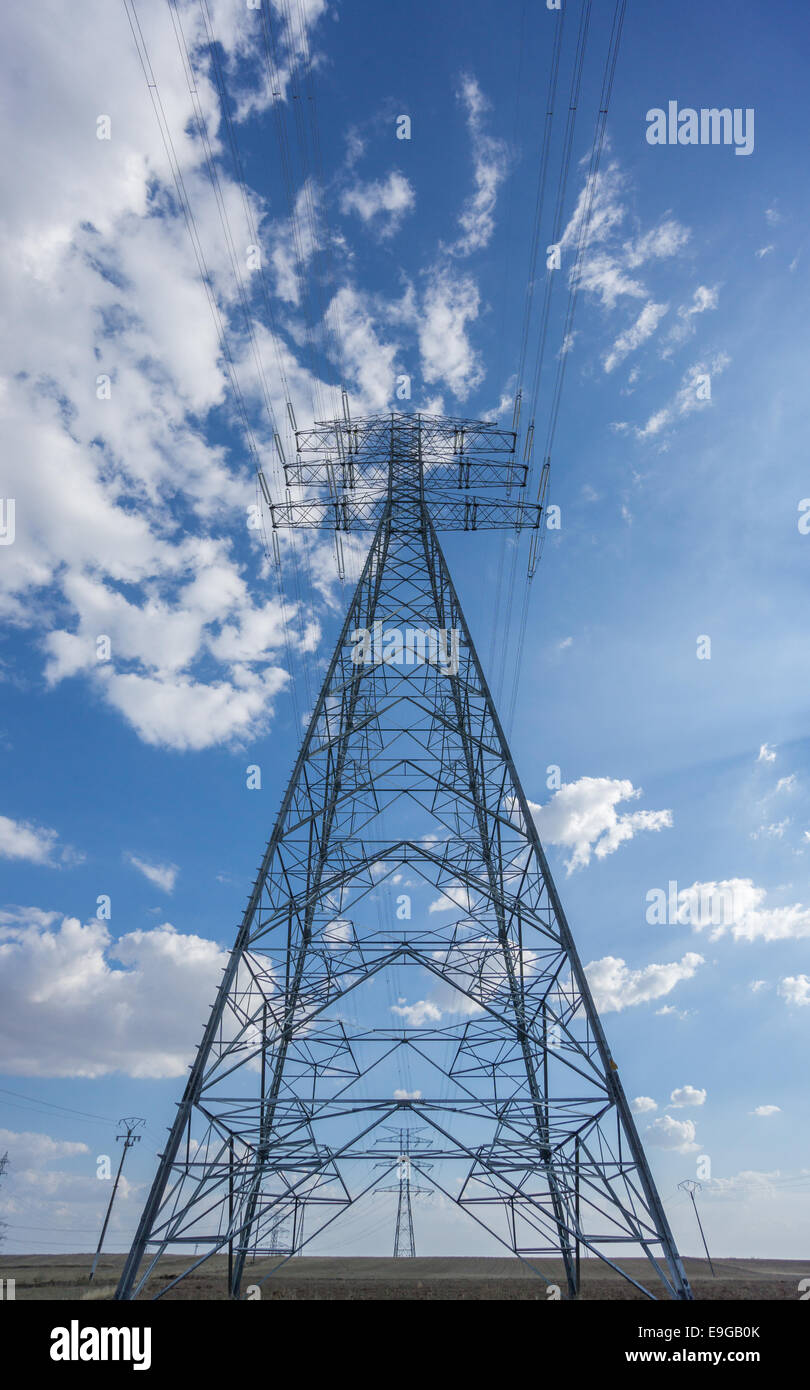 Centered Electric tower over blue sky and clouds, vertical composition ...