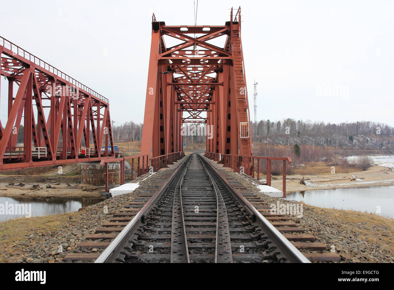 Red metal railway bridge across the river Stock Photo - Alamy