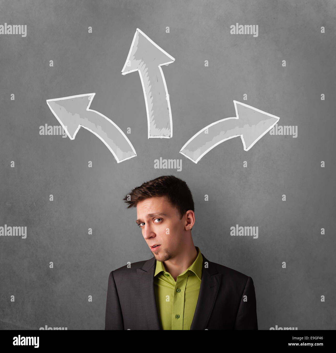 Businessman thinking with arrows above his head Stock Photo - Alamy