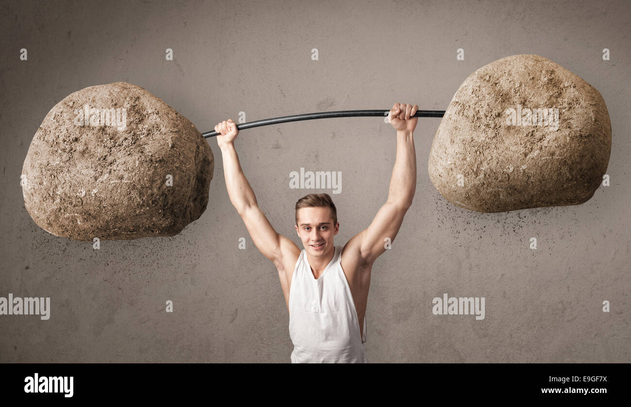 muscular man lifting large rock stone weights Stock Photo - Alamy