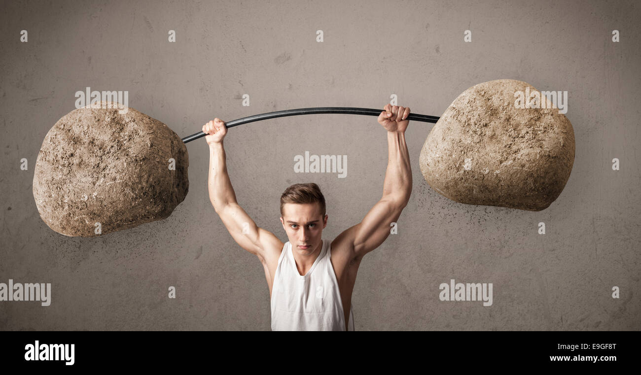 muscular man lifting large rock stone weights Stock Photo - Alamy