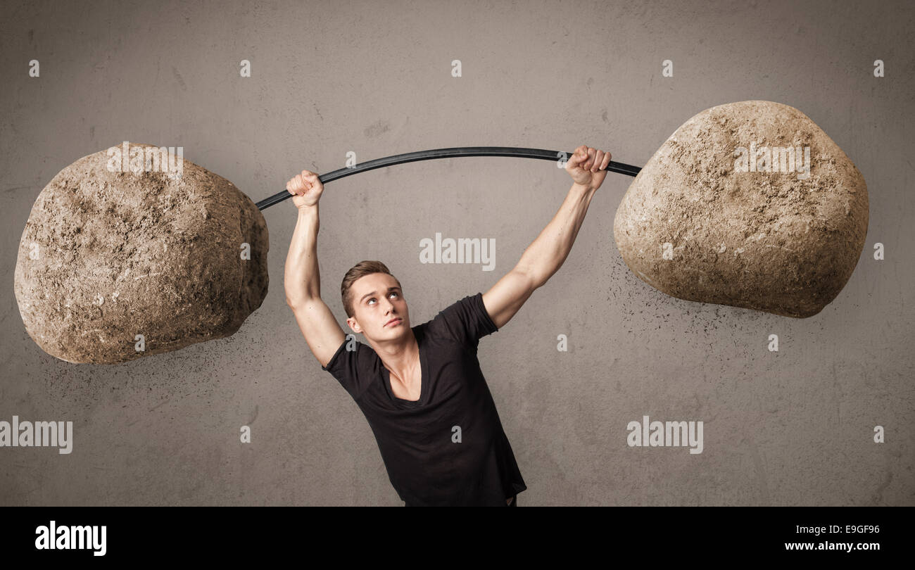 muscular man lifting large rock stone weights Stock Photo - Alamy