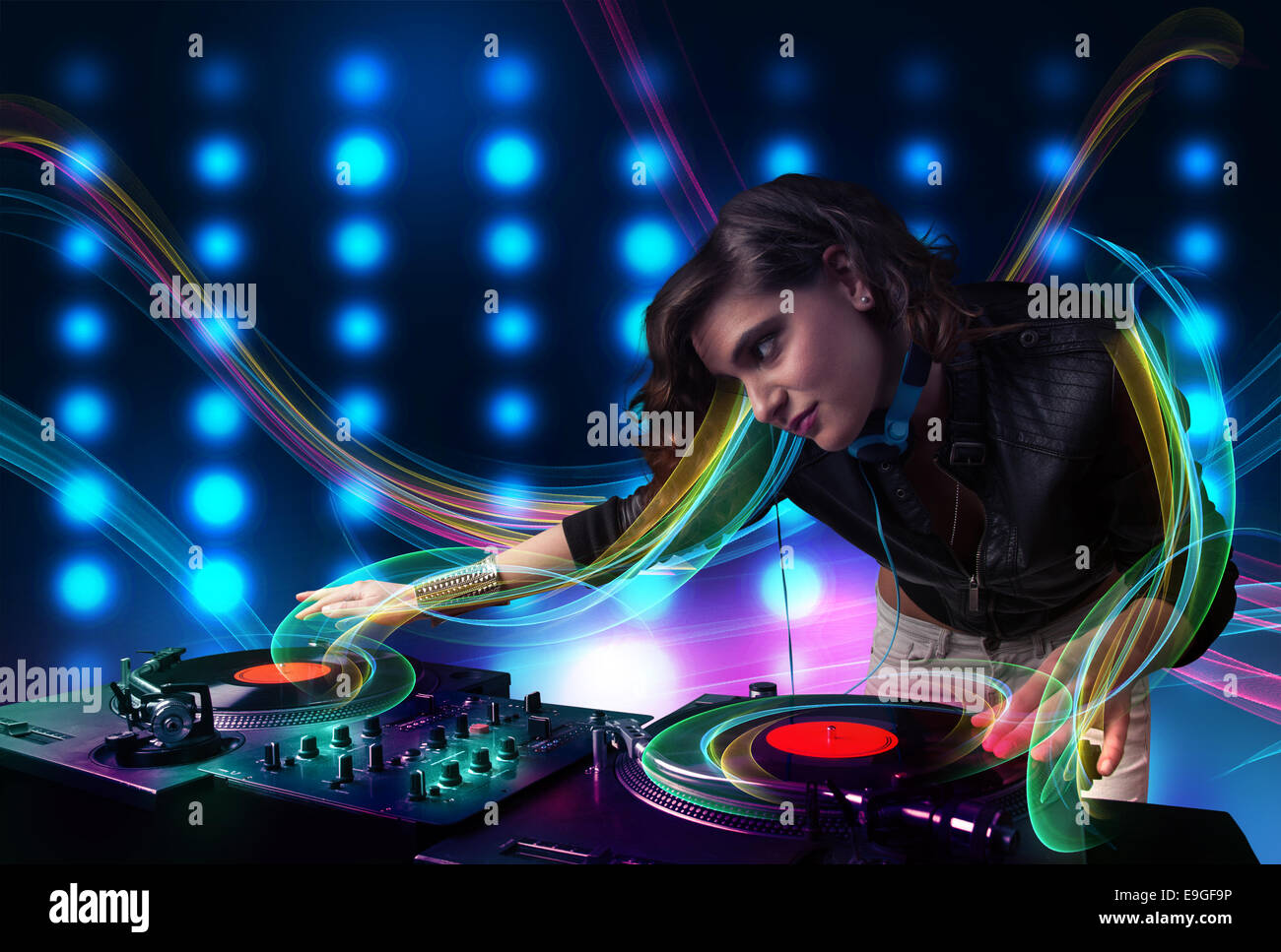Young Dj girl mixing records with colorful lights Stock Photo - Alamy