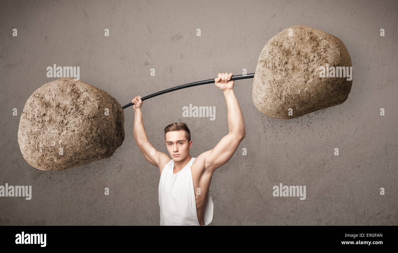 muscular man lifting large rock stone weights Stock Photo - Alamy