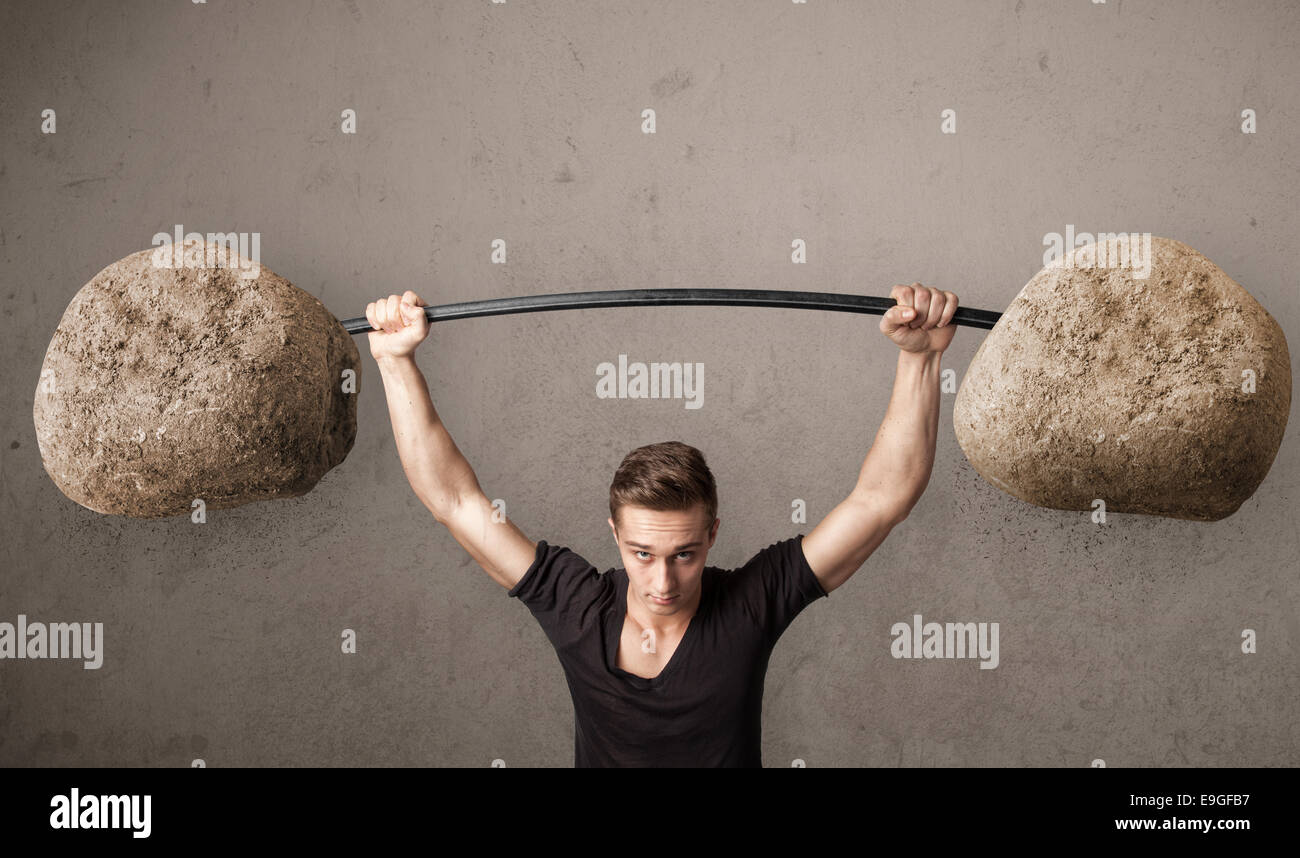 muscular man lifting large rock stone weights Stock Photo - Alamy
