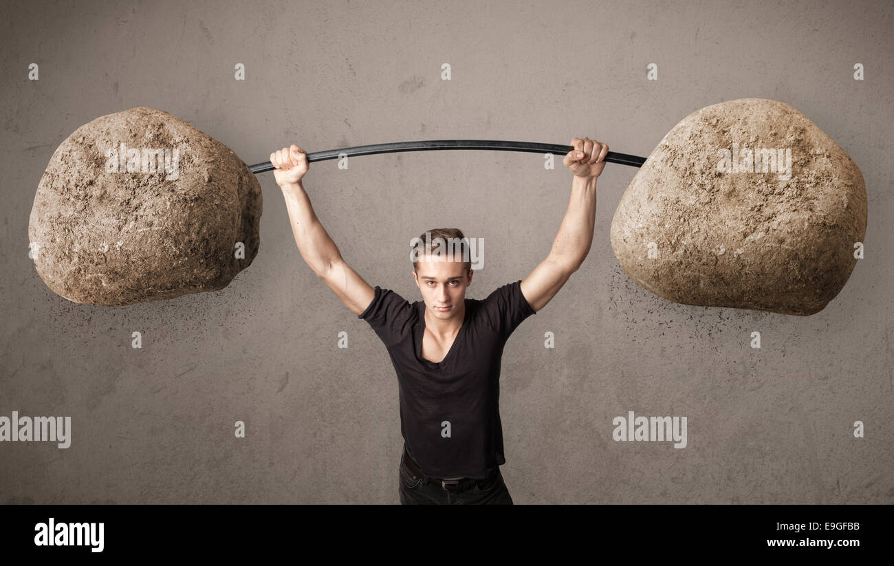 muscular man lifting large rock stone weights Stock Photo - Alamy