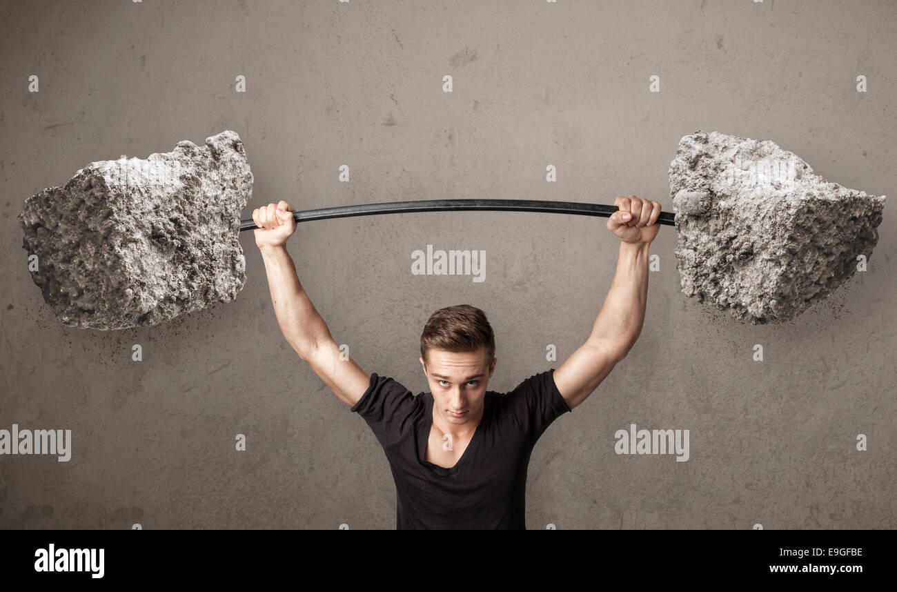 muscular man lifting large rock stone weights Stock Photo - Alamy
