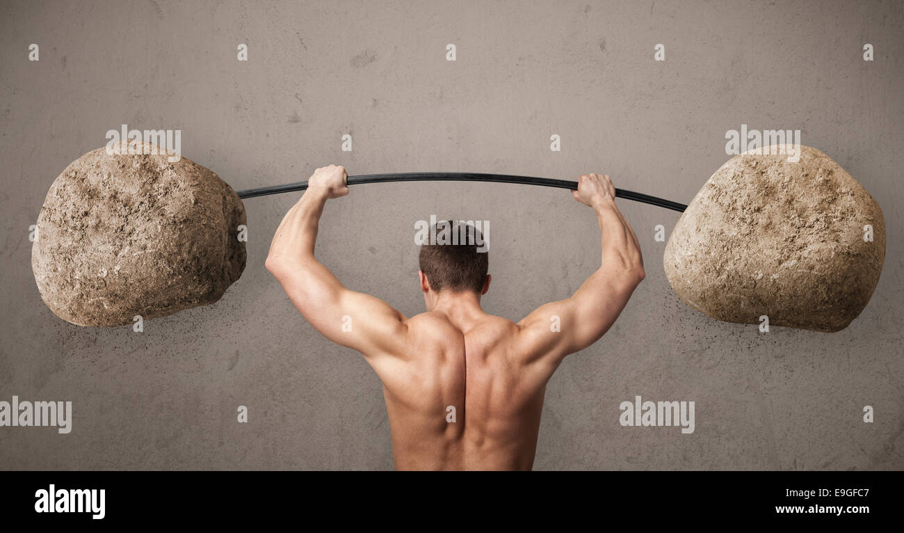 muscular man lifting large rock stone weights Stock Photo - Alamy
