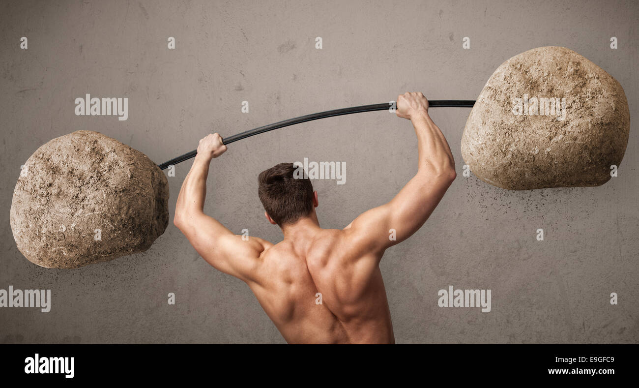 muscular man lifting large rock stone weights Stock Photo - Alamy