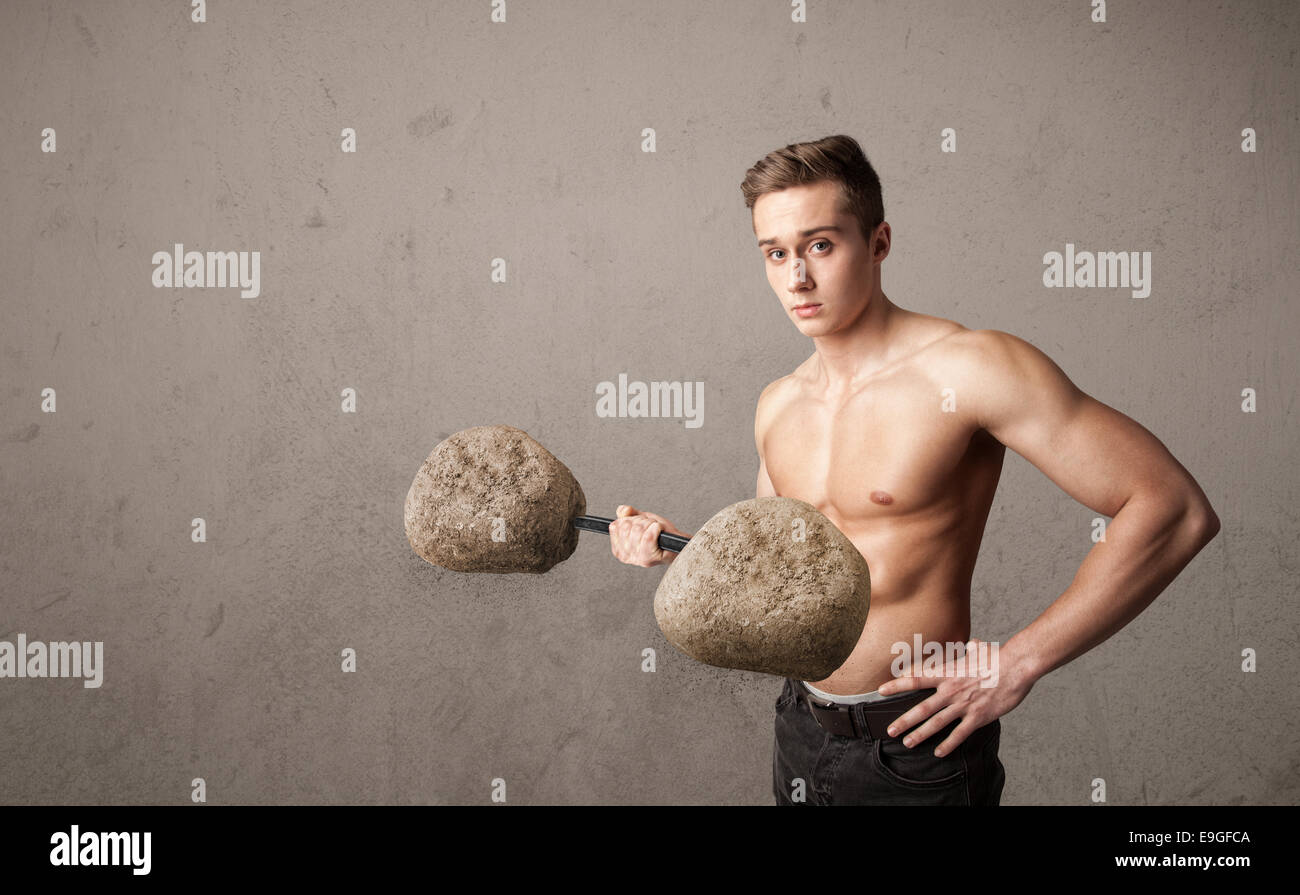 muscular man lifting large rock stone weights Stock Photo - Alamy