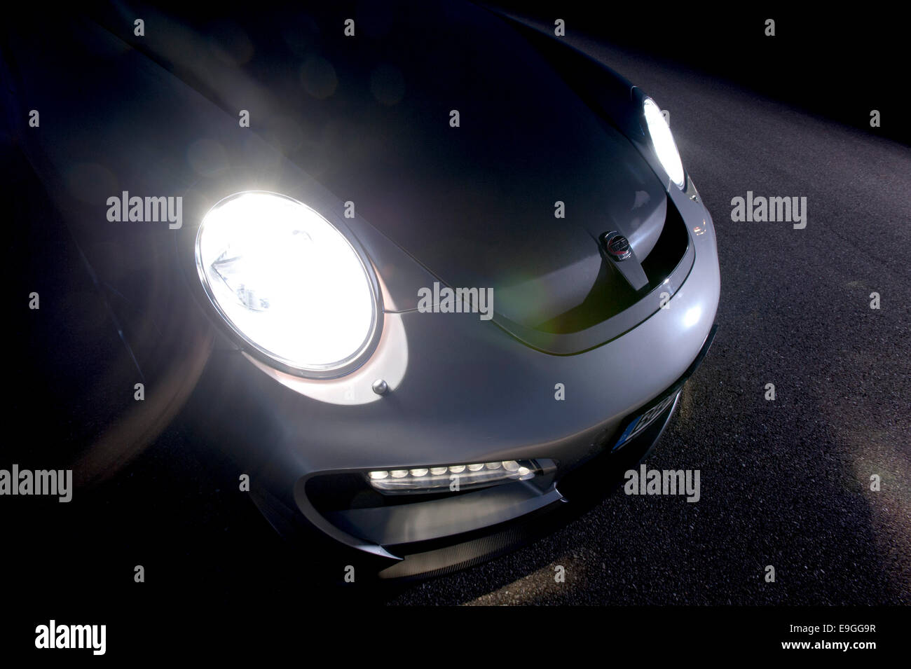 Porsche car headlights bright in the dark Stock Photo - Alamy