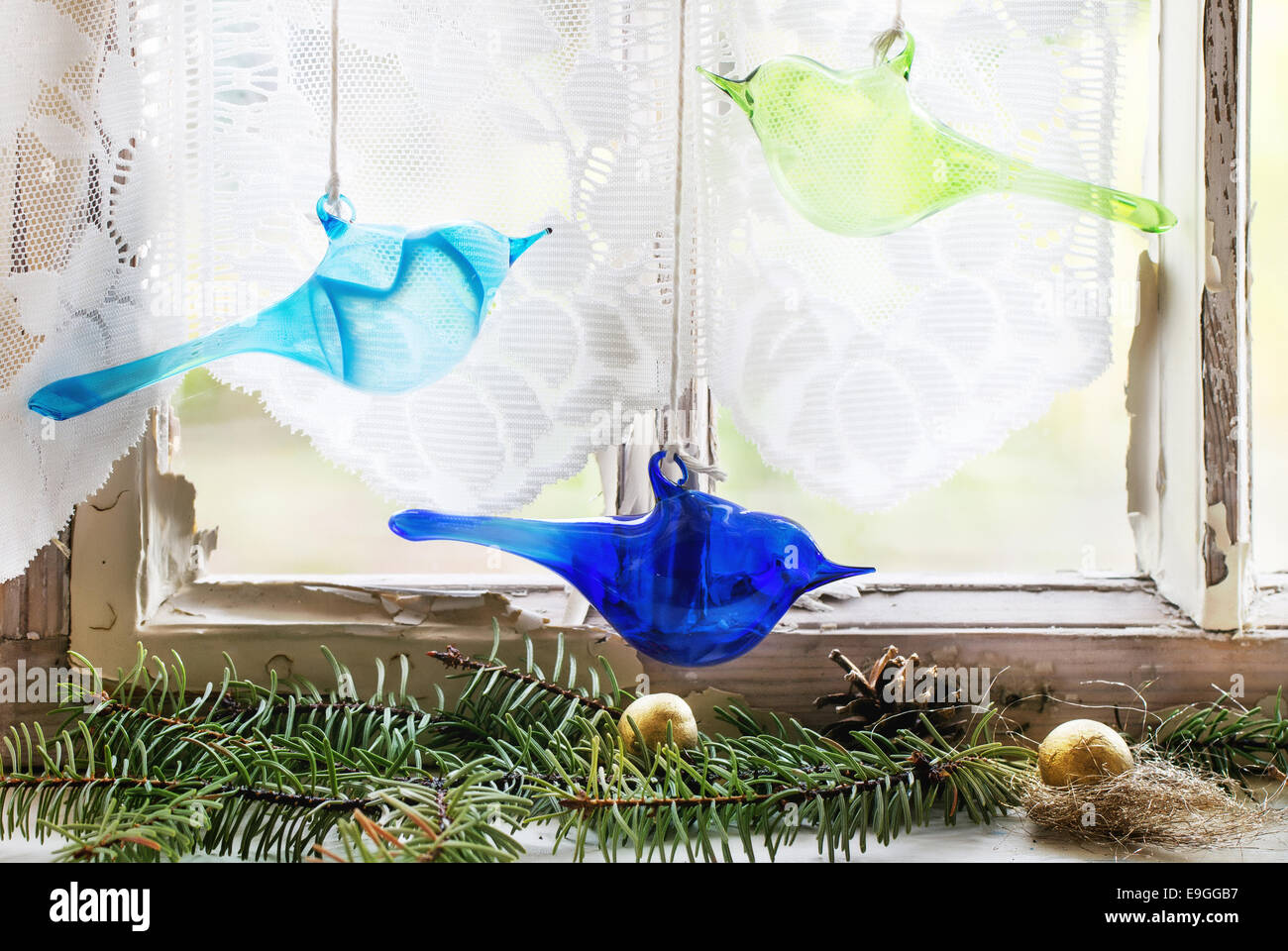 Interior window with glass birds and christmas tree Stock Photo - Alamy