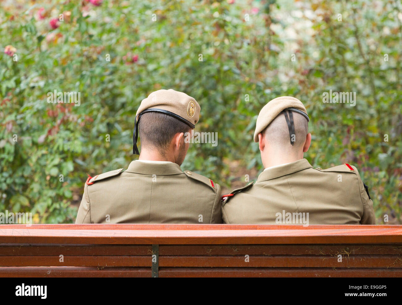 Two Spanish armed forces personnel sitting on park bench. Spain, Europe ...