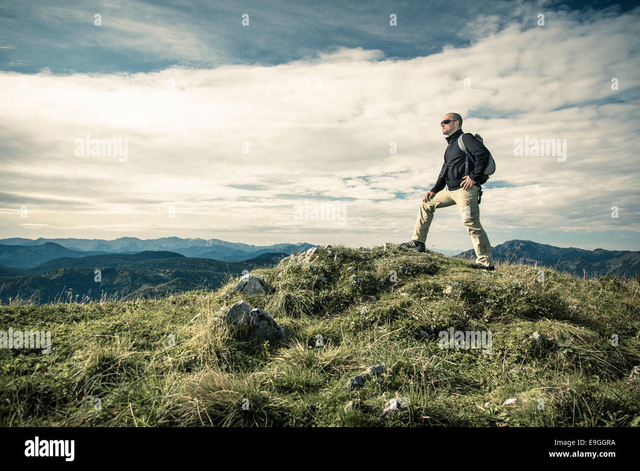 Man looking into the mountain landscape Stock Photo - Alamy
