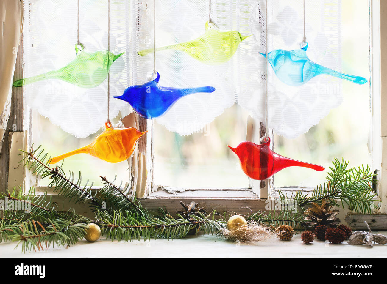 Interior window with glass birds and christmas tree Stock Photo - Alamy
