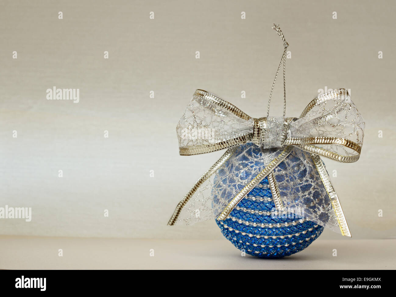 Blue Christmas ball with ribbon bow on a silver background Stock Photo ...