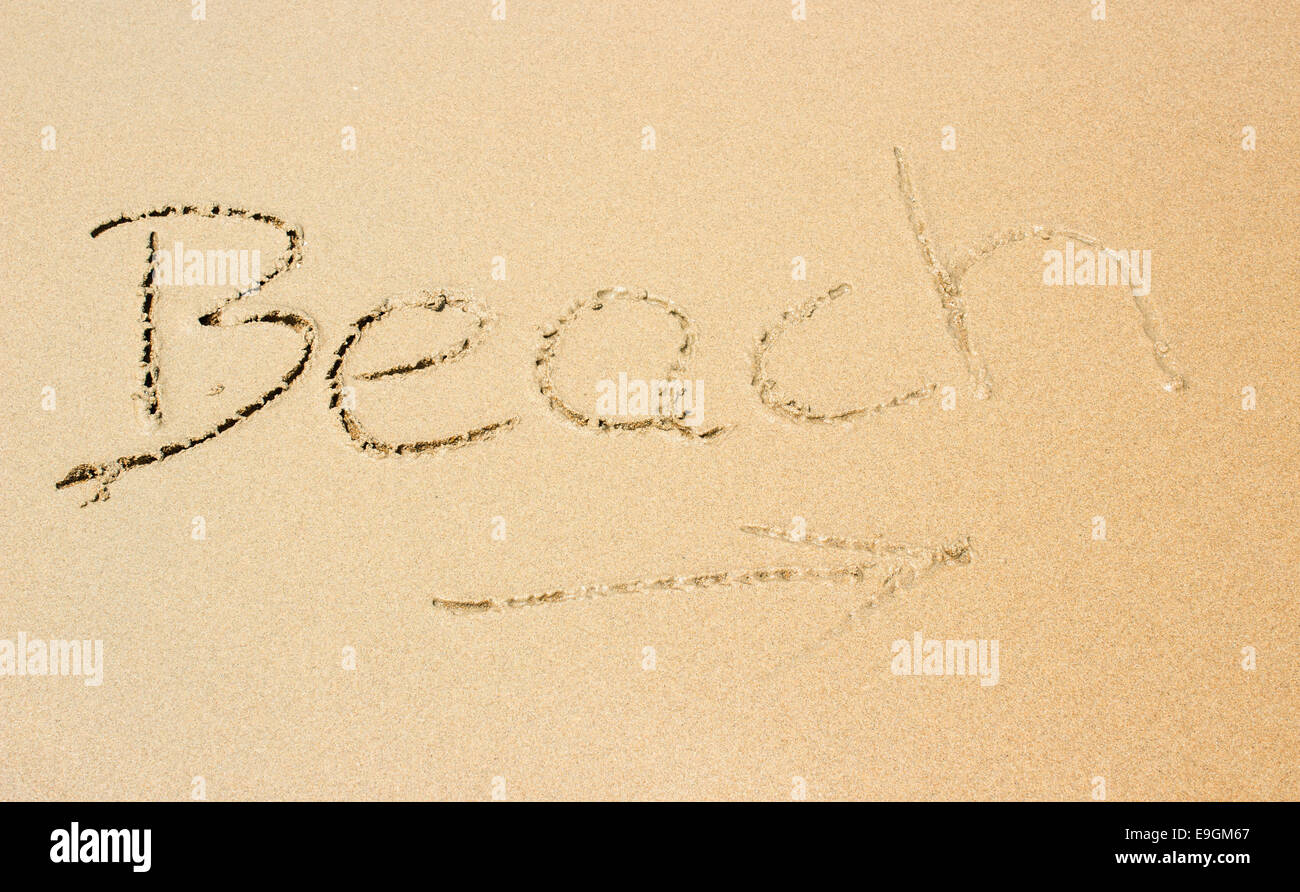 sand with lettering beach and arrow Stock Photo - Alamy