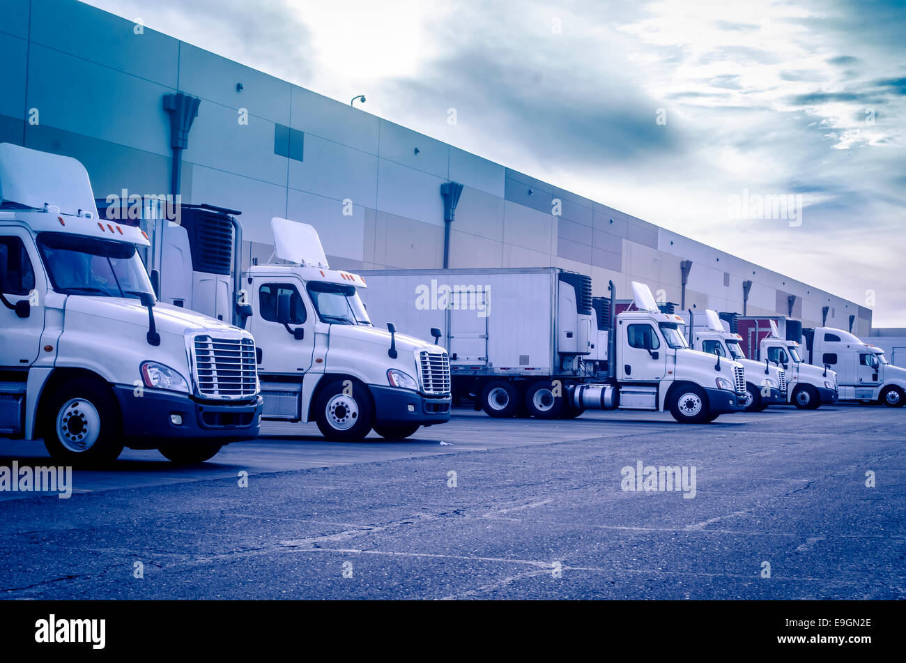 Trucks lorrys loading unloading at warehouse Stock Photo - Alamy