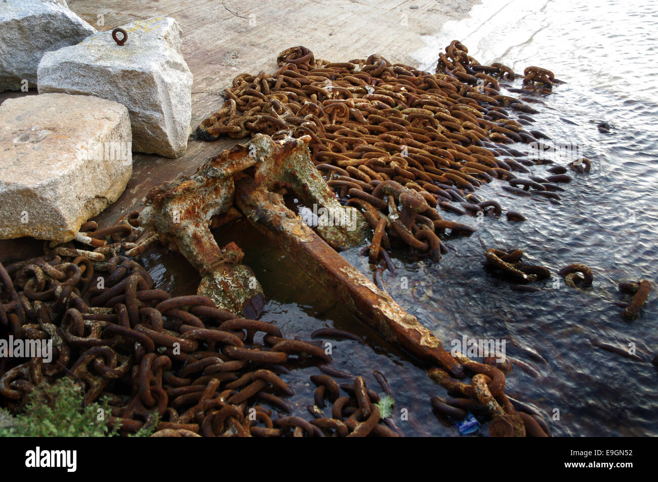 Rusting anchor at the sea's edge Stock Photo - Alamy