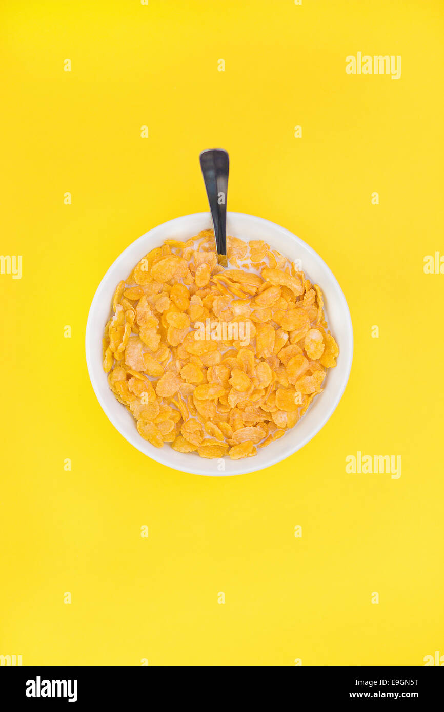 cereal bowl with spoon on yellow background Stock Photo - Alamy