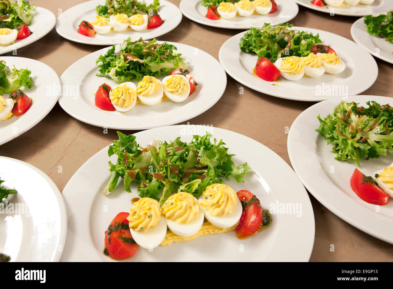 many dishes in the kitchen with salad and decorated eggs, ready for ...