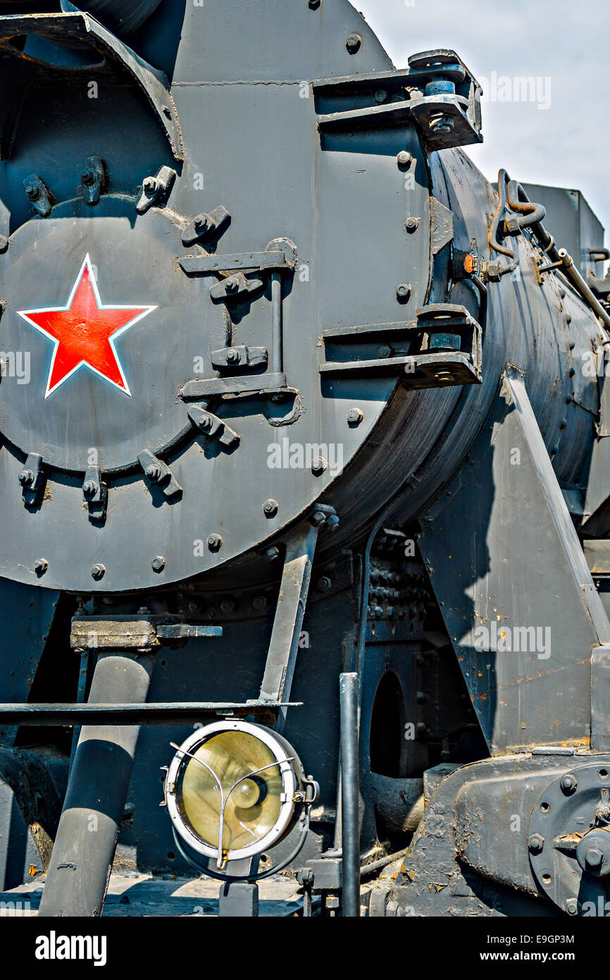 Partial frontal view of a steam locomotive. Gray metal boiler and ...