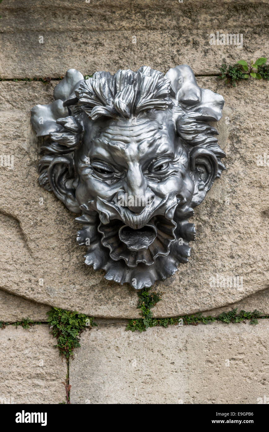 An Auguste Rodin mask on a wall in Jardin des Serres d'Auteuil in the ...