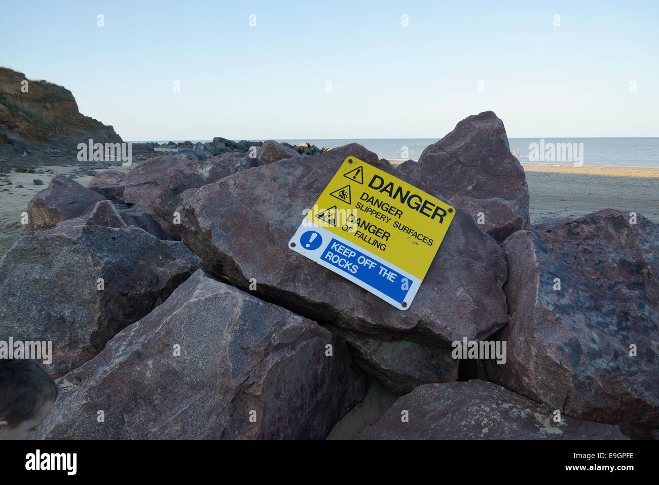 A danger sign on rocks at Happisburgh, Norfolk, UK Stock Photo - Alamy