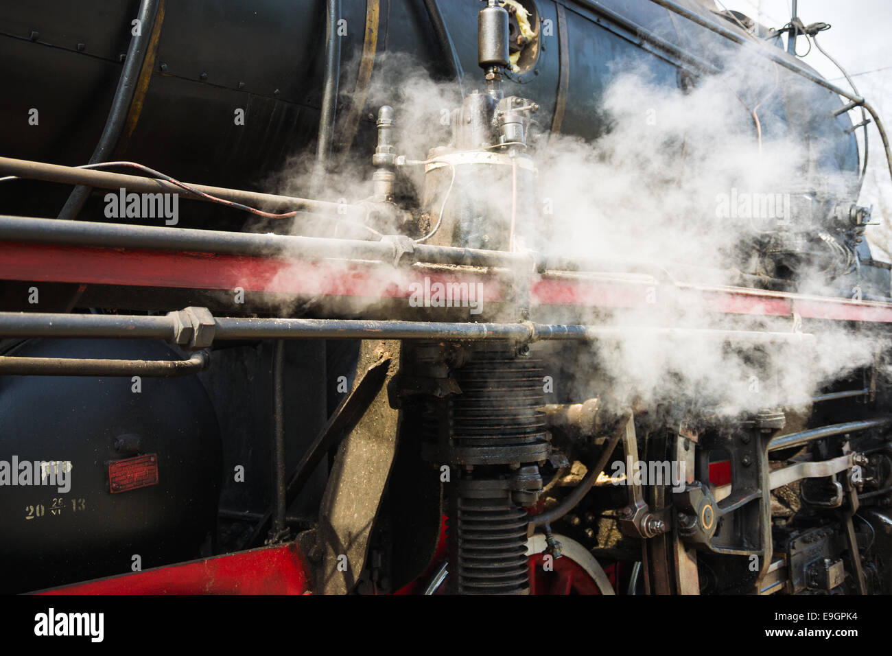 Steam locomotive in steam and ready to depart. Live hot steam around ...