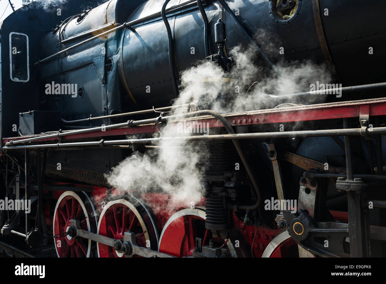 Steam locomotive in steam and ready to depart. Live hot steam around ...