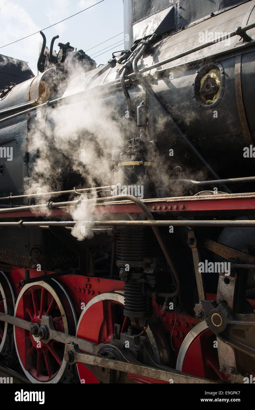 Steam locomotive in steam and ready to depart. Live hot steam around ...