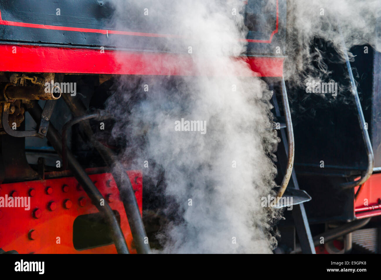 Steam locomotive in steam and ready to depart. Live hot steam around ...
