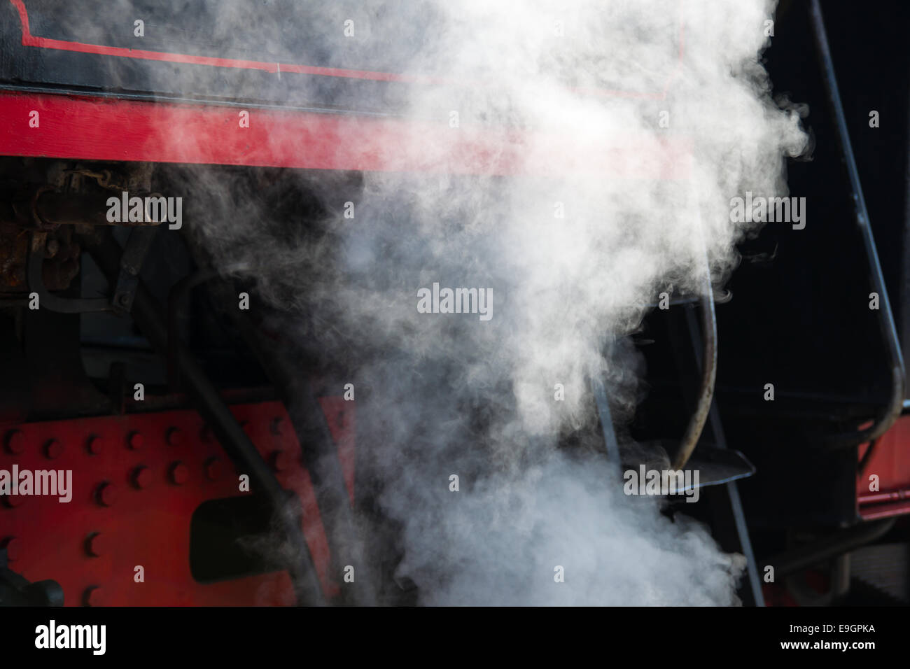 Steam locomotive in steam and ready to depart. Live hot steam around ...