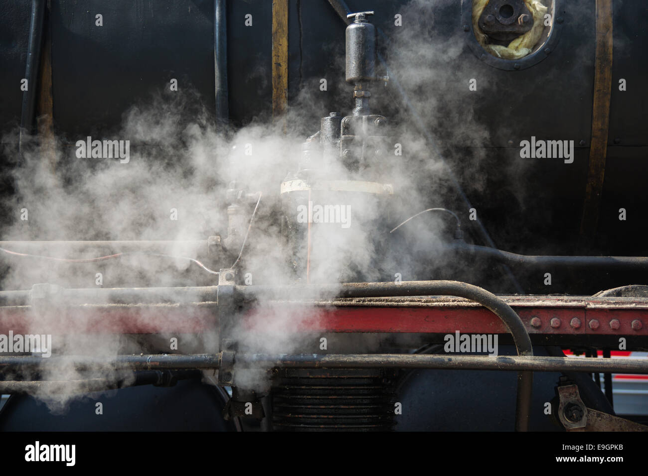 Steam locomotive in steam and ready to depart. Live hot steam around ...