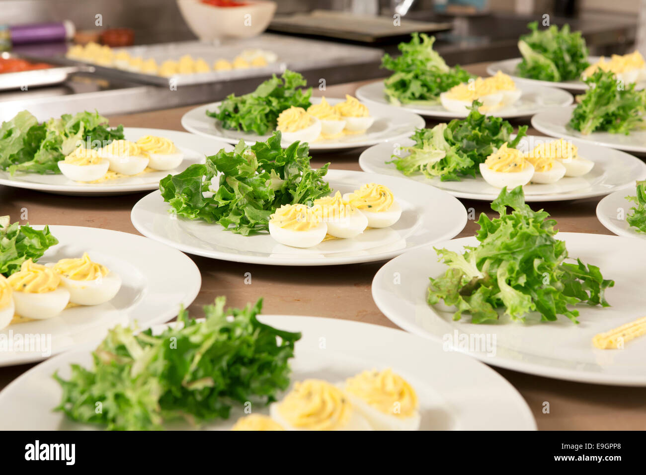 many dishes in the kitchen with salad and decorated eggs, ready for ...