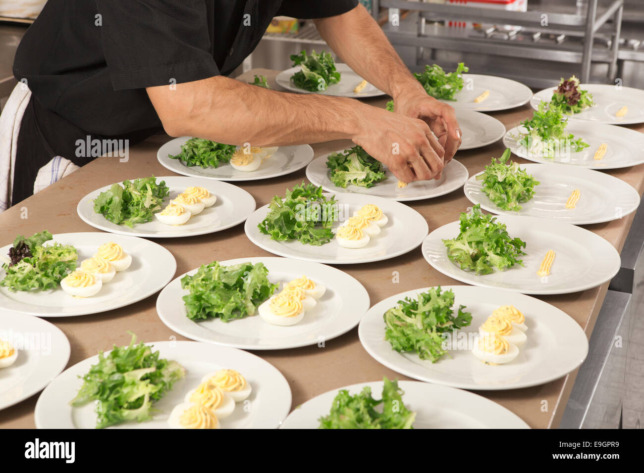 many dishes in the kitchen with salad and decorated eggs, ready for ...