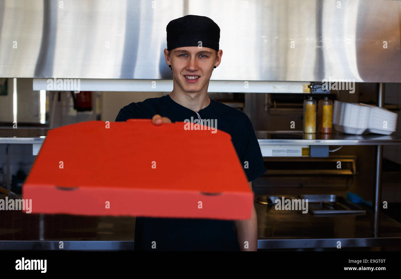 Boy delivering pizza at fast food restaurant Stock Photo - Alamy