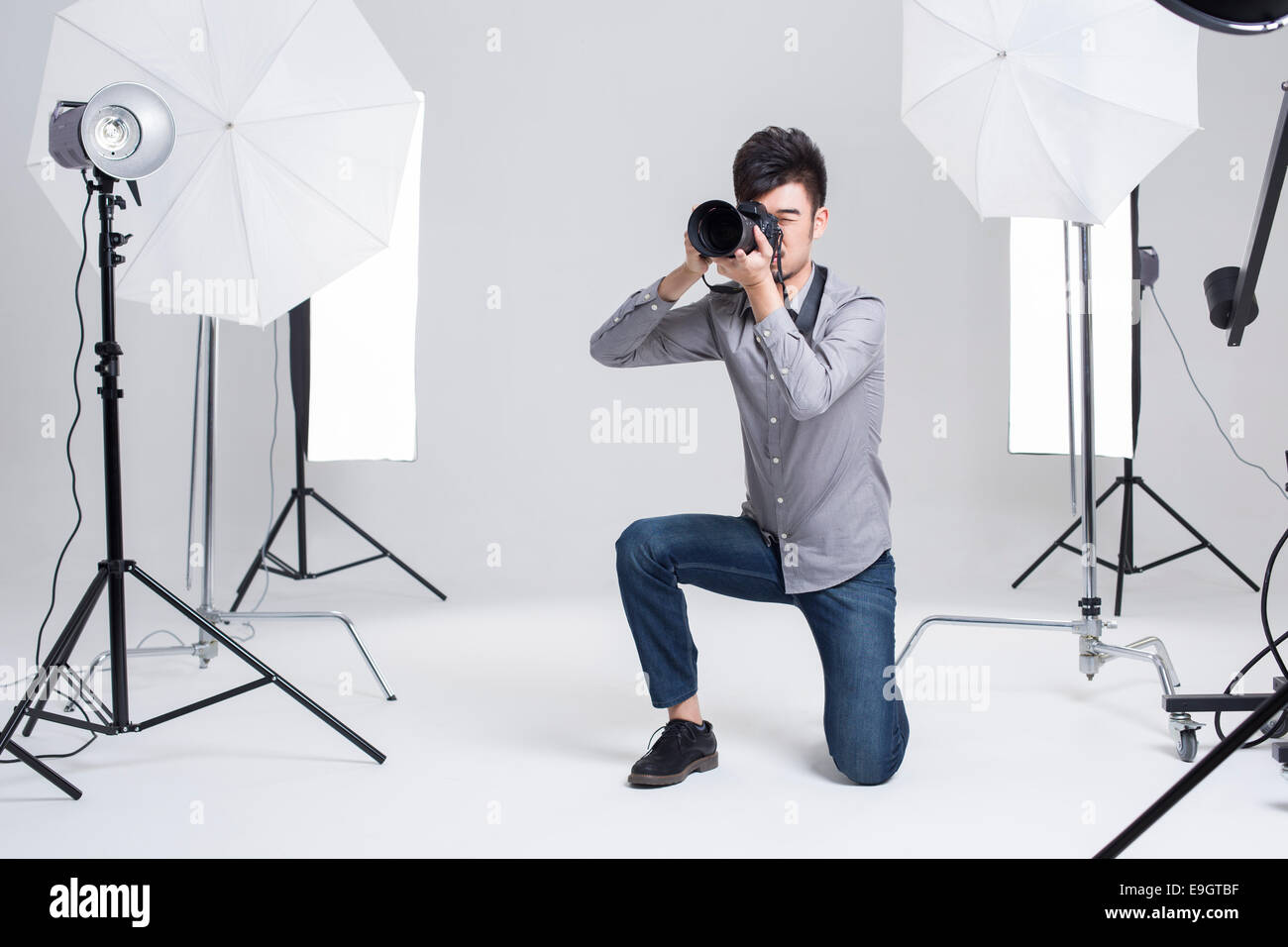 Photographer taking picture in studio Stock Photo - Alamy