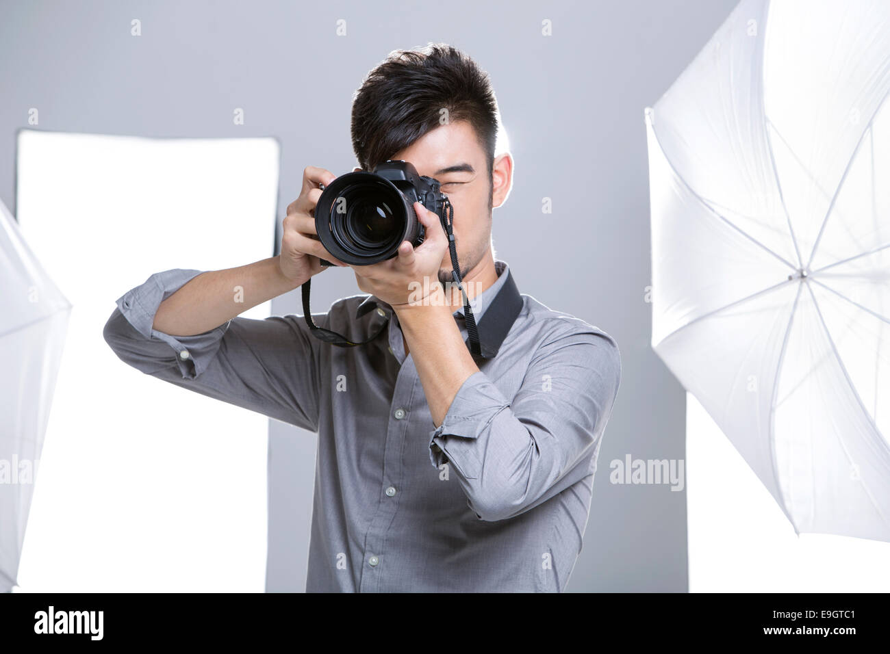 Photographer taking picture in studio Stock Photo - Alamy