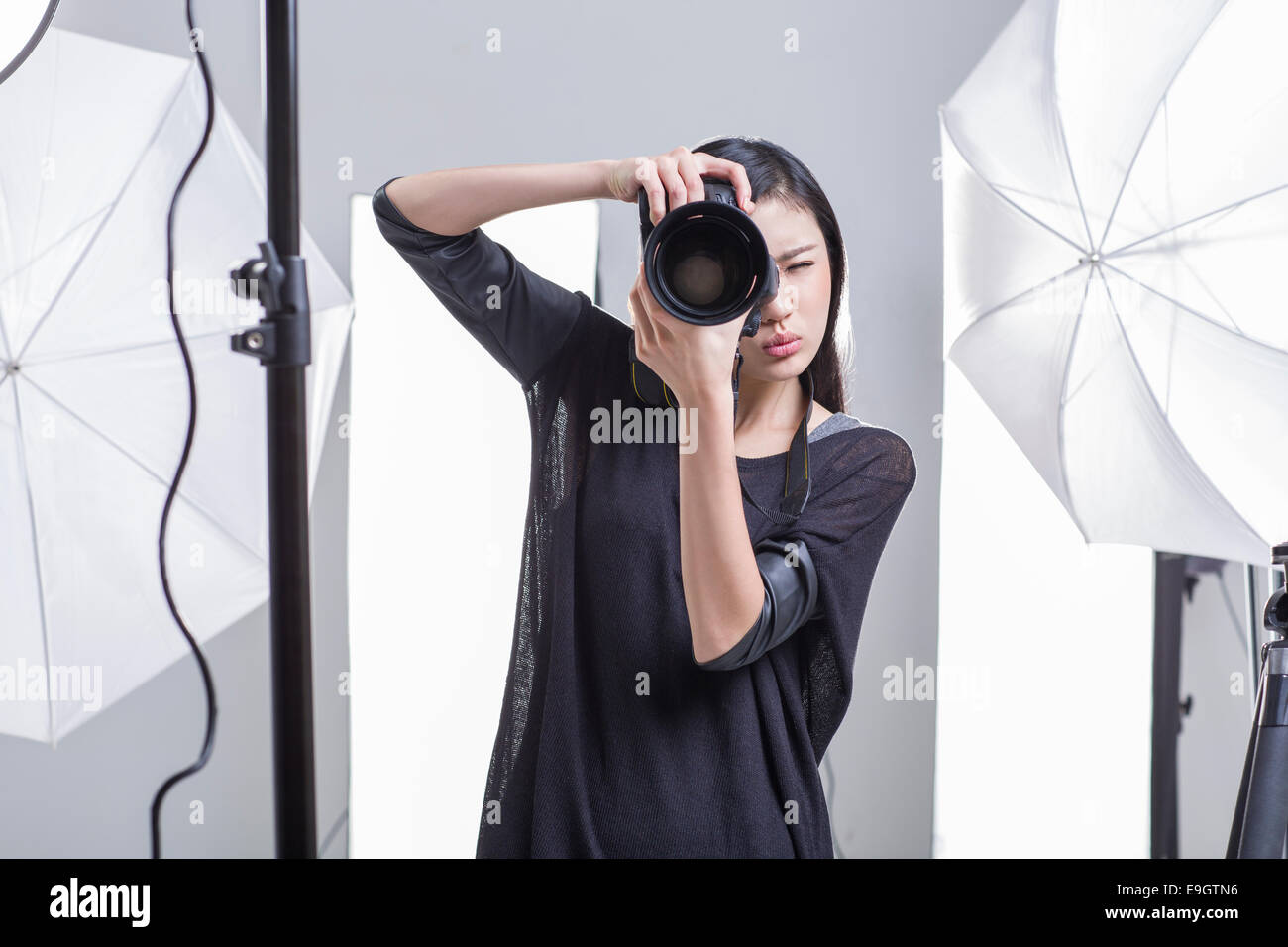 Photographer taking picture in studio Stock Photo - Alamy