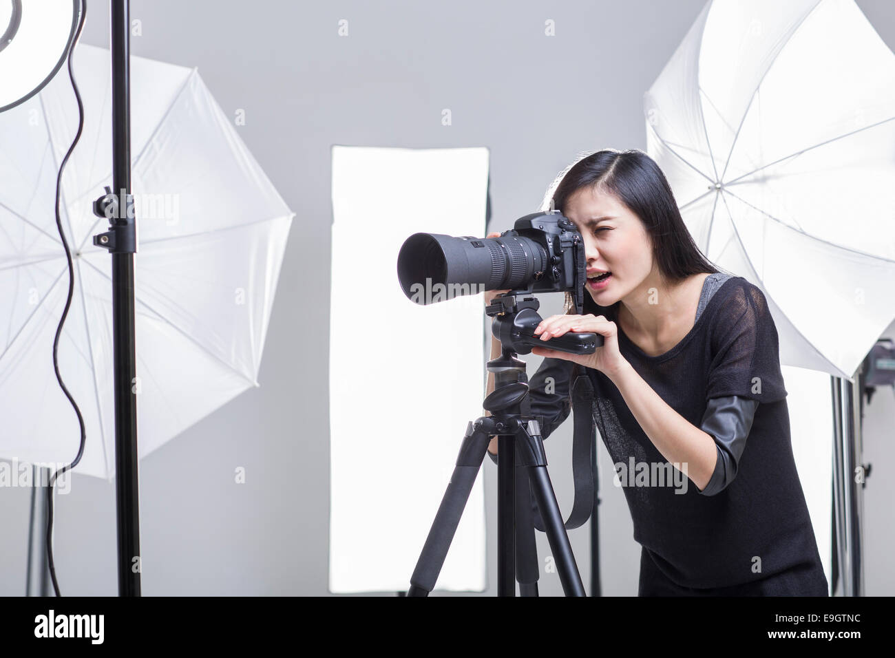 Photographer taking picture in studio Stock Photo - Alamy