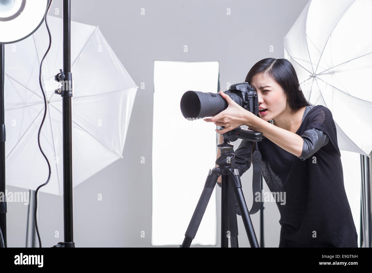 Photographer taking picture in studio Stock Photo - Alamy