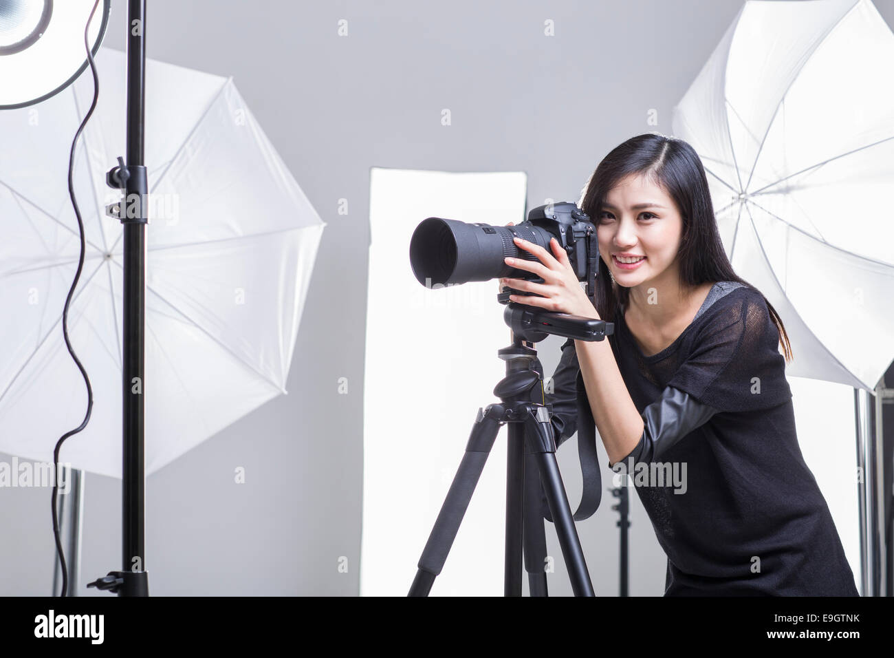Photographer taking picture in studio Stock Photo - Alamy